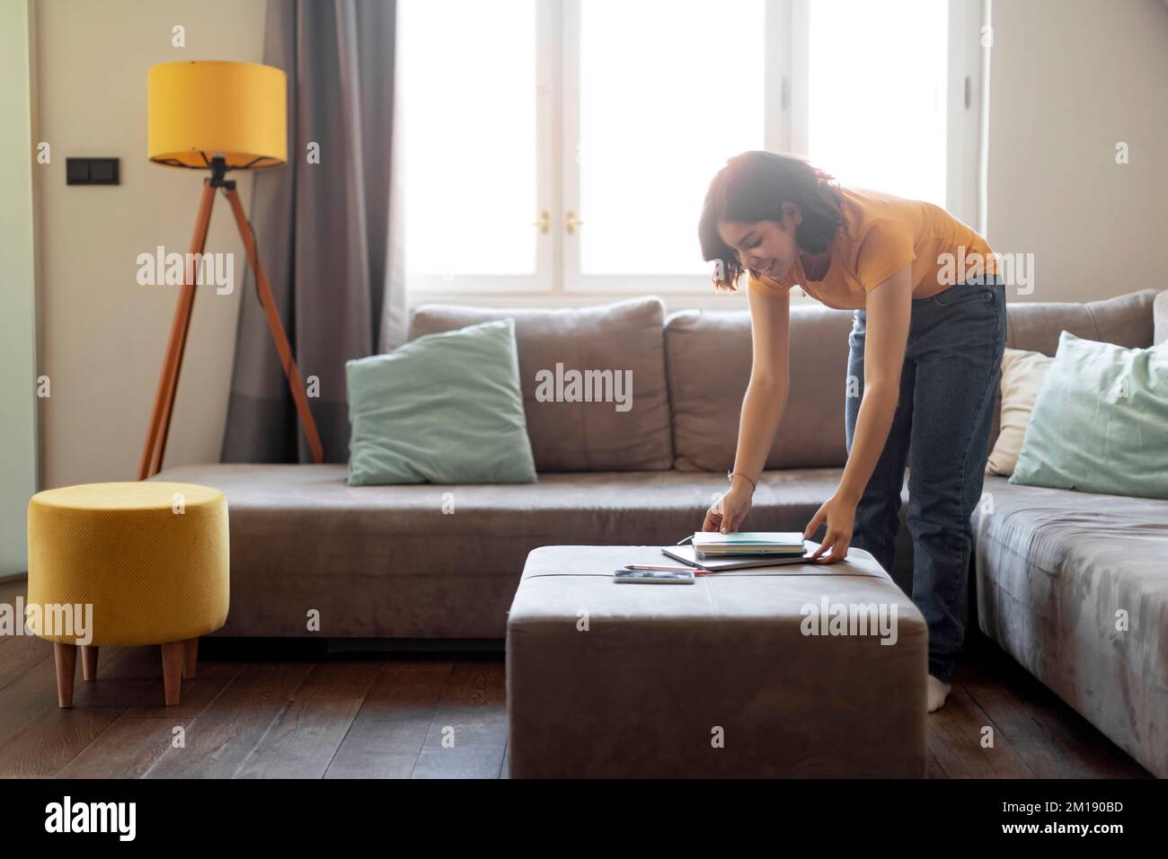 Young Smiling Arab Woman Doing Cleaning In Living Room At Home Stock ...