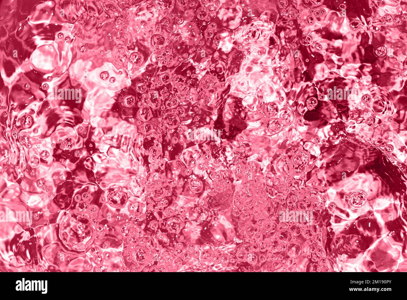 Toned in magenta Pool or hot tub water background. Ripples on deep pink ...