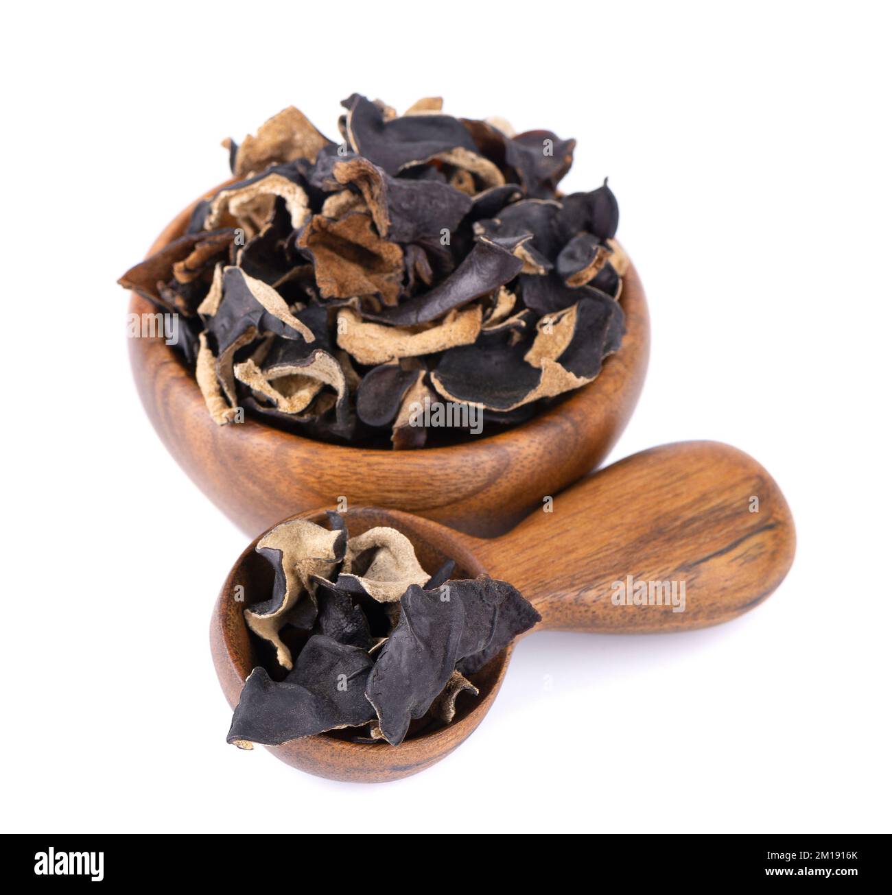 Dry black fungus in wooden bowl and spoon, isolated on white background ...