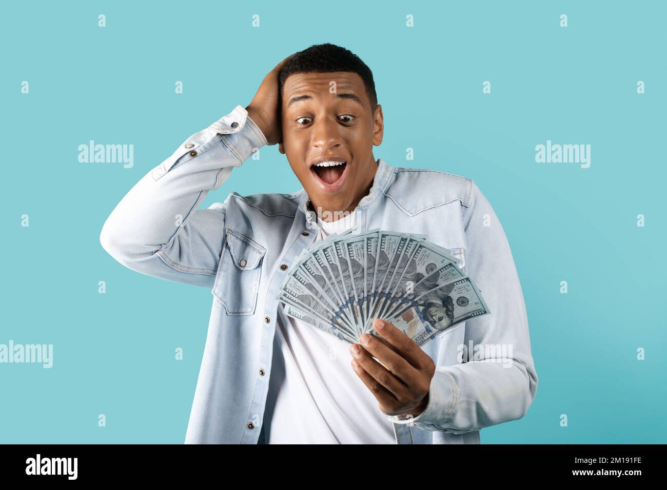 Surprised smiling excited young african american male in casual with ...