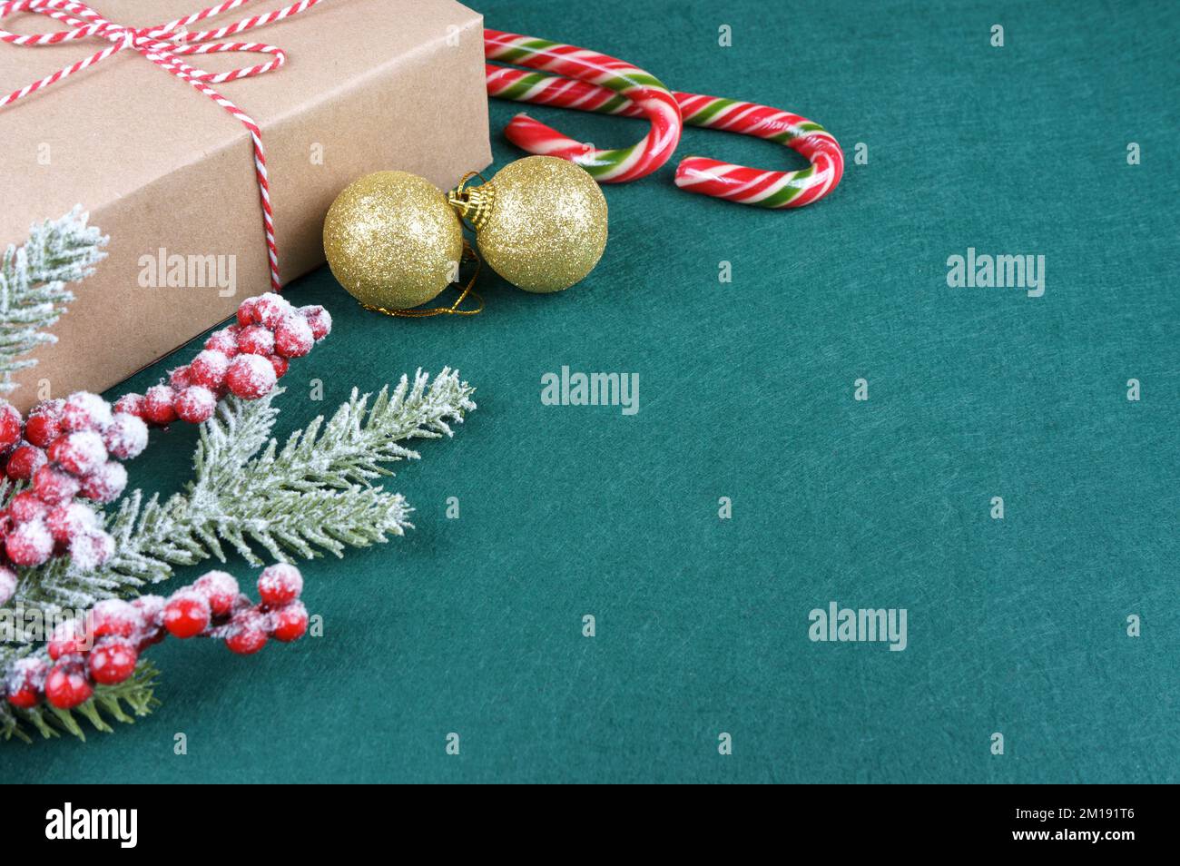 New year background with christmas tree branch, candy, golden balls and ...