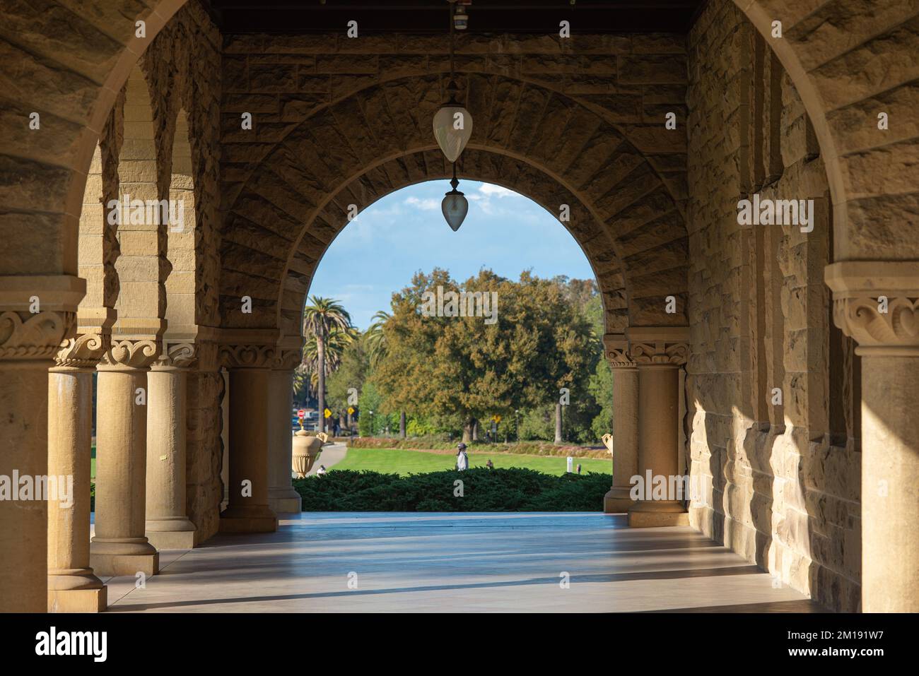 An outdoor corridor of a historic building with columns Stock Photo - Alamy