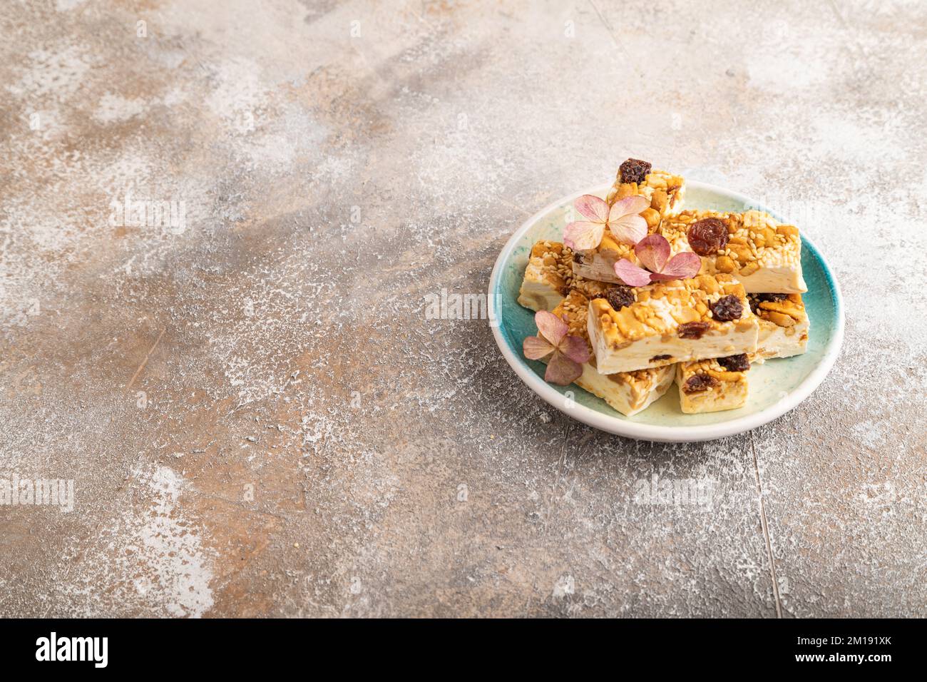 Traditional candy nougat with nuts and sesame on brown concrete ...