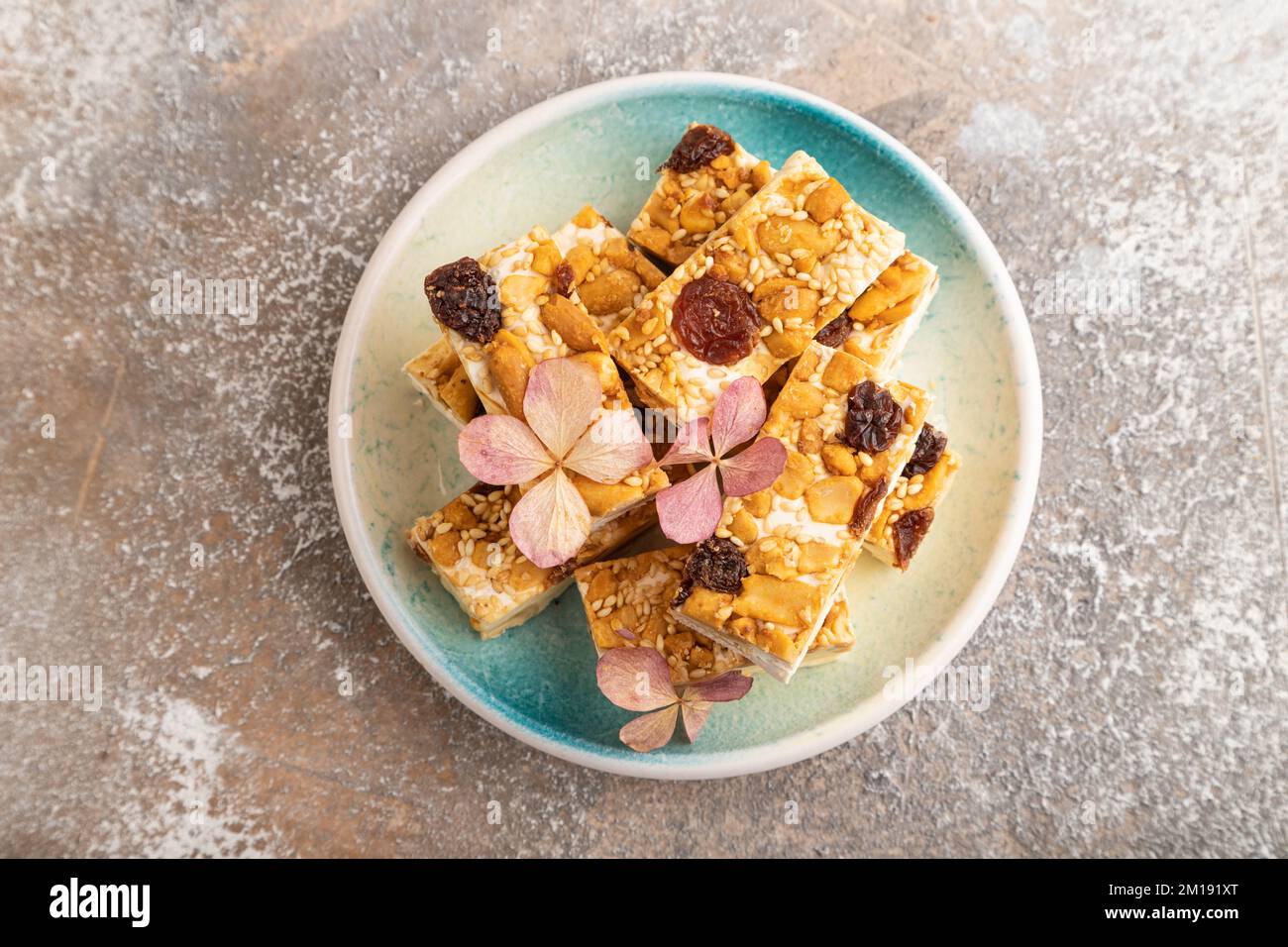 Traditional candy nougat with nuts and sesame on brown concrete ...