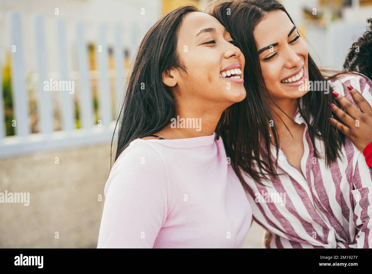 Latin friends having fun hugging outdoor - Focus on left girl face ...