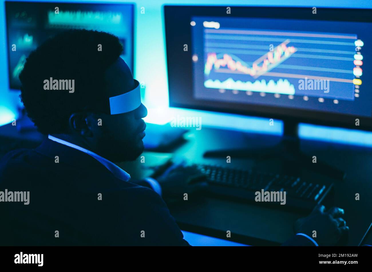 African trader working inside office ath night time wearing virtual reality headset - Trading ...