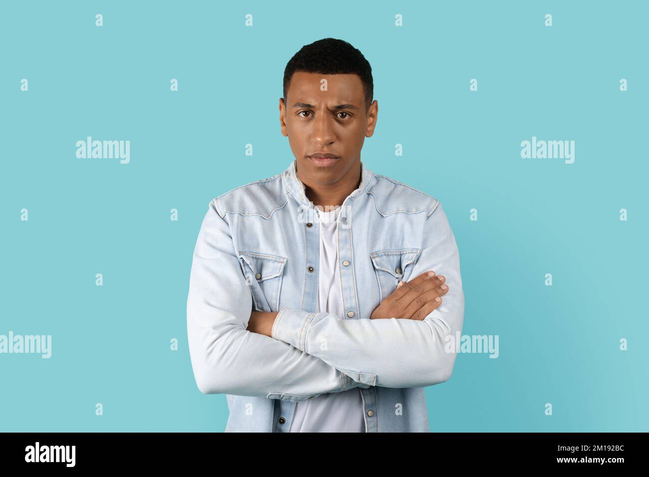 Angry sad serious displeased young african american man with crossed arms on chest Stock Photo ...
