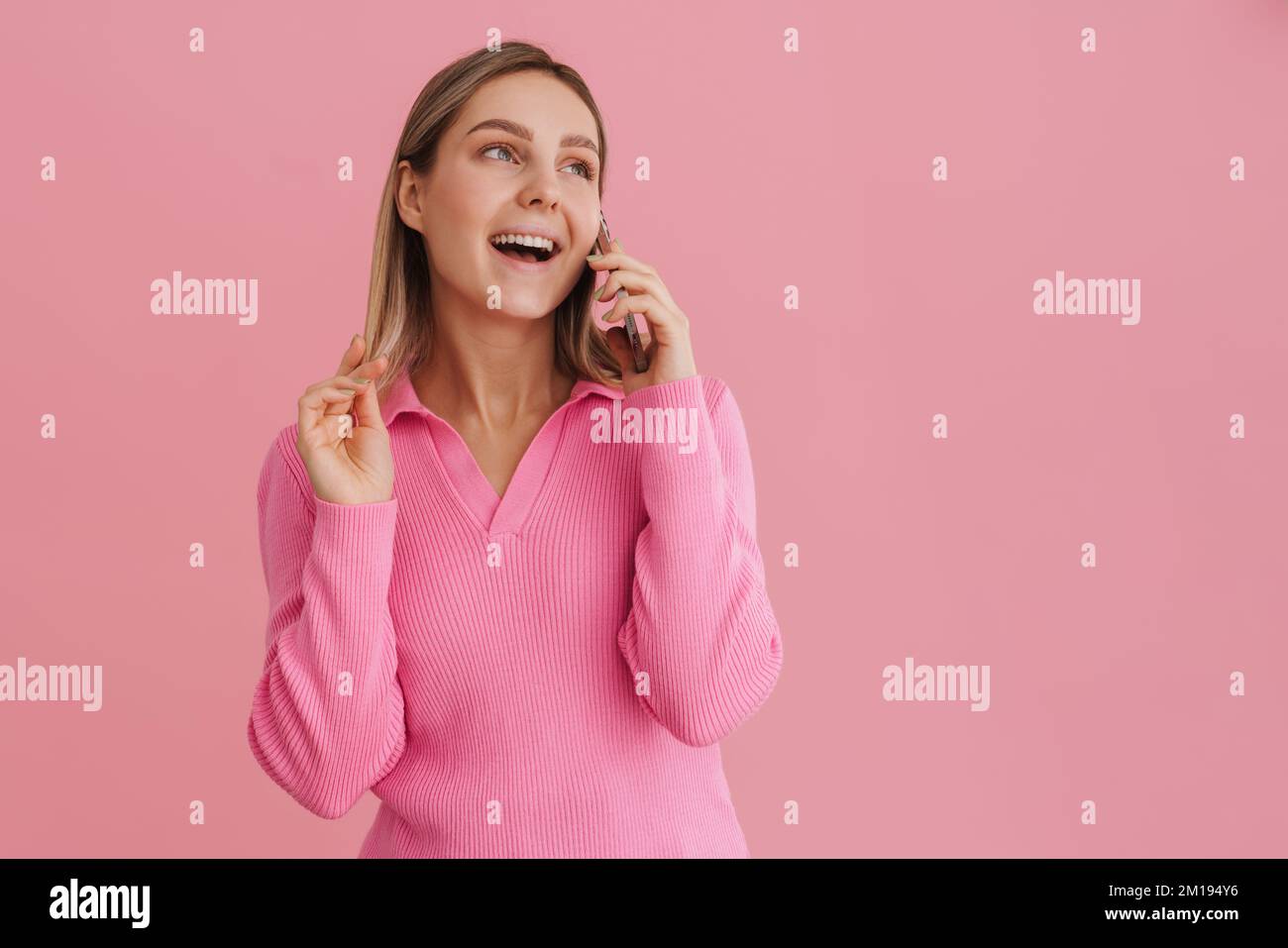 Young attractive girl plays with her hair with opened mouth while ...