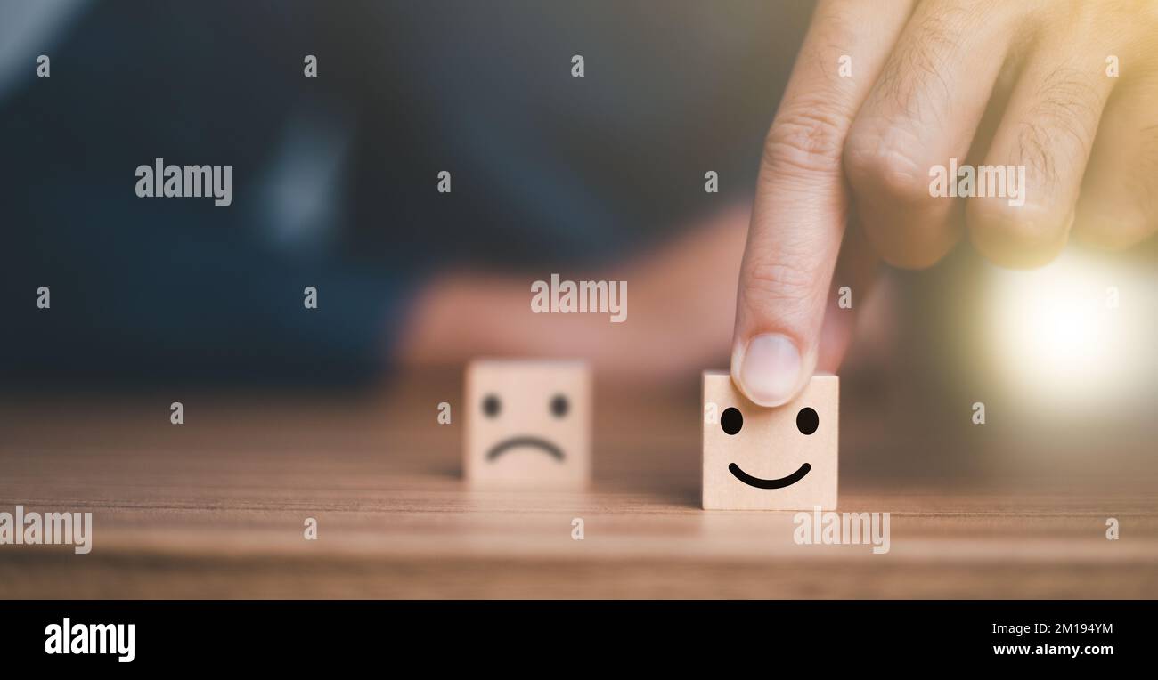 Close up customer hand choose smile face and blurred sad face icon on ...