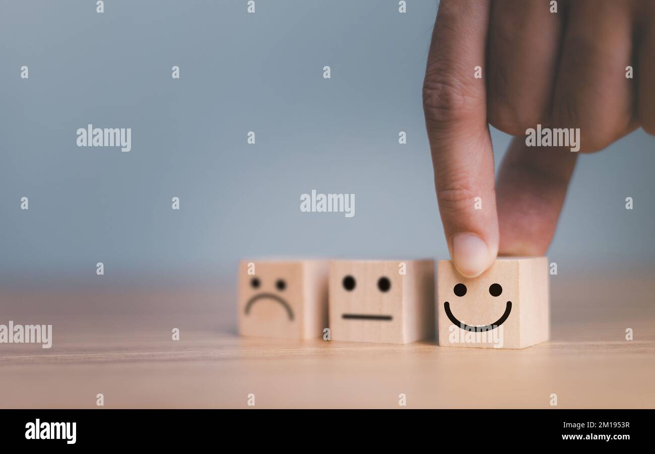 Close up customer hand choose smile face and blurred sad face icon on ...