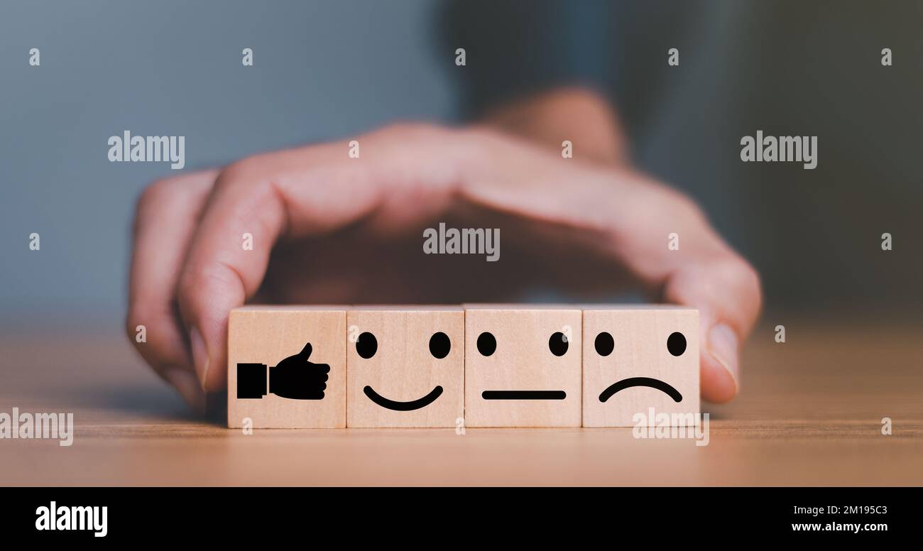 Close up customer hand choose smile face and blurred sad face icon on ...