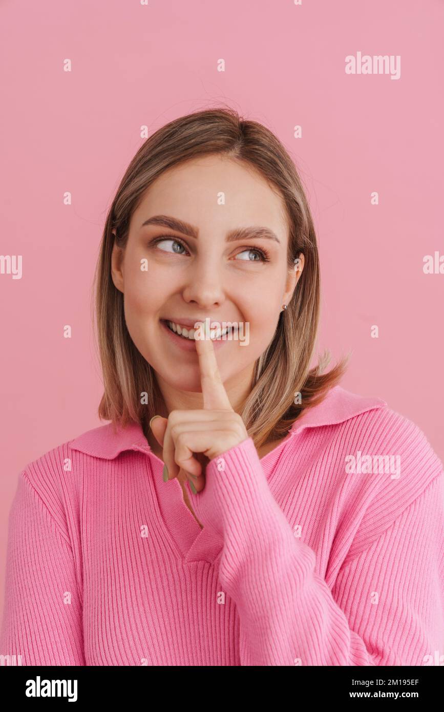 Portrait of young beautiful girl showing silence gesture looking ...