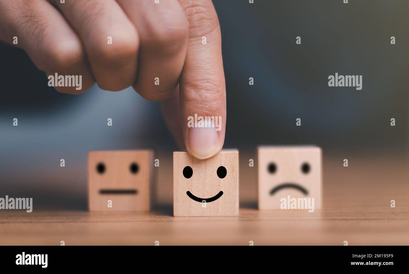 Close up customer hand choose smile face and blurred sad face icon on ...