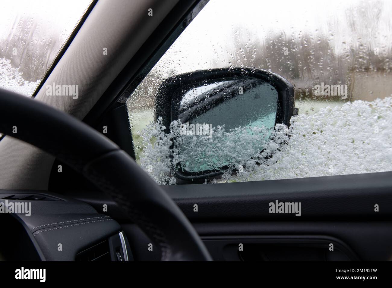Snow and ice on car windscreen dangerous weather and driving conditions ...