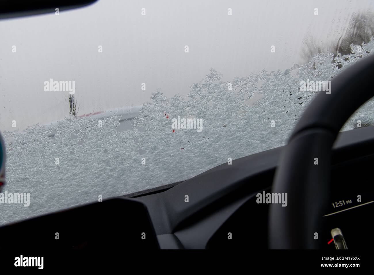 Snow and ice on car windscreen dangerous weather and driving conditions ...