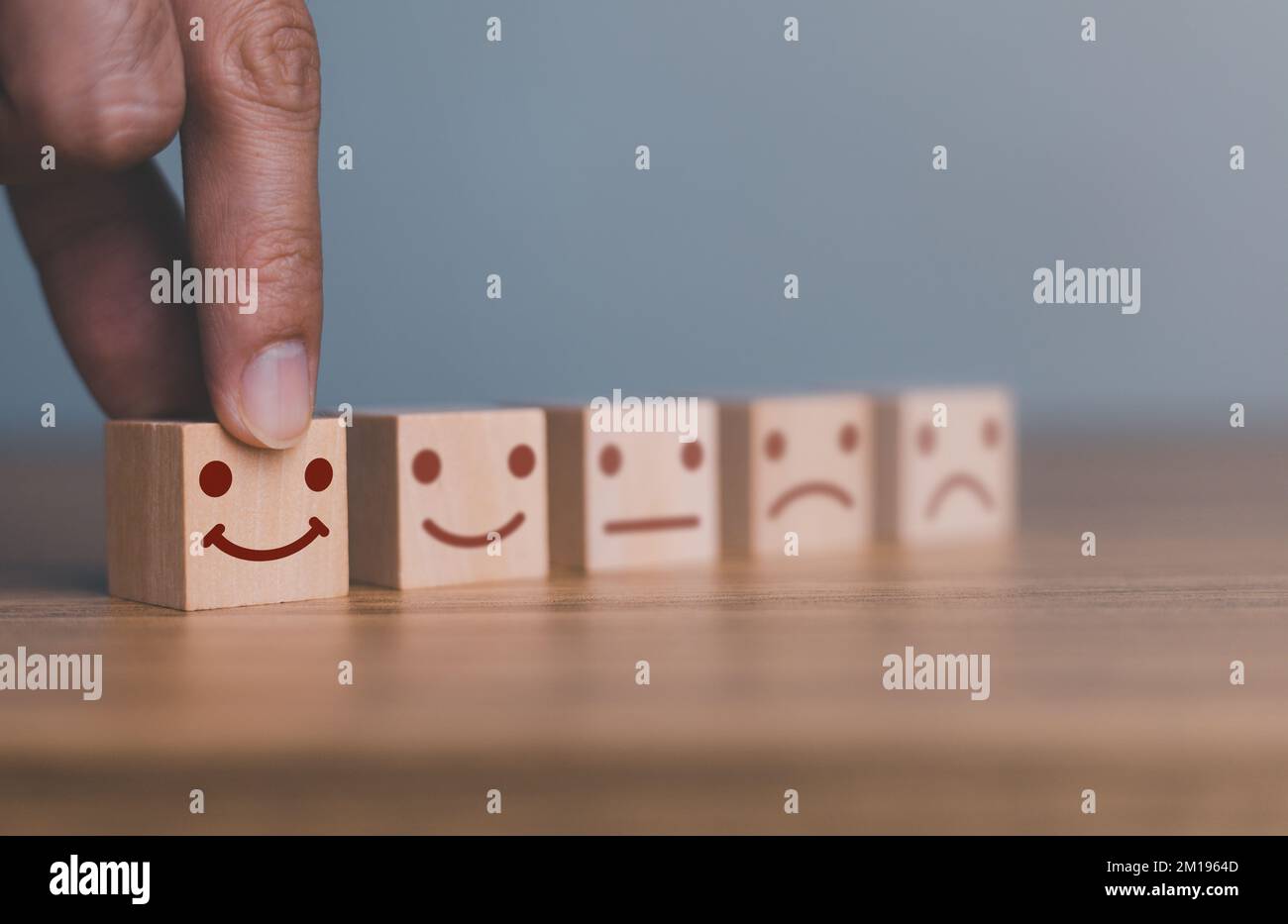 Close up customer hand choose smile face and blurred sad face icon on ...