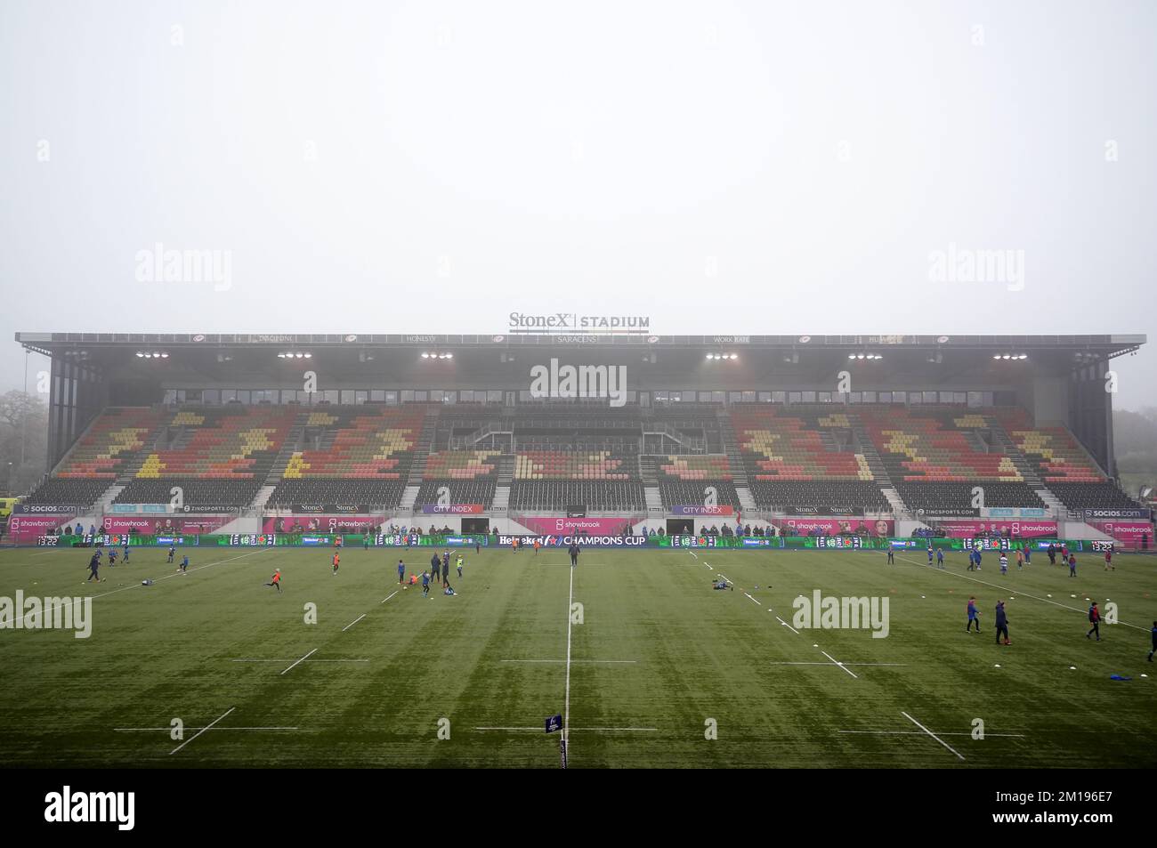 A general view of players warming up on a foggy pitch ahead of the ...