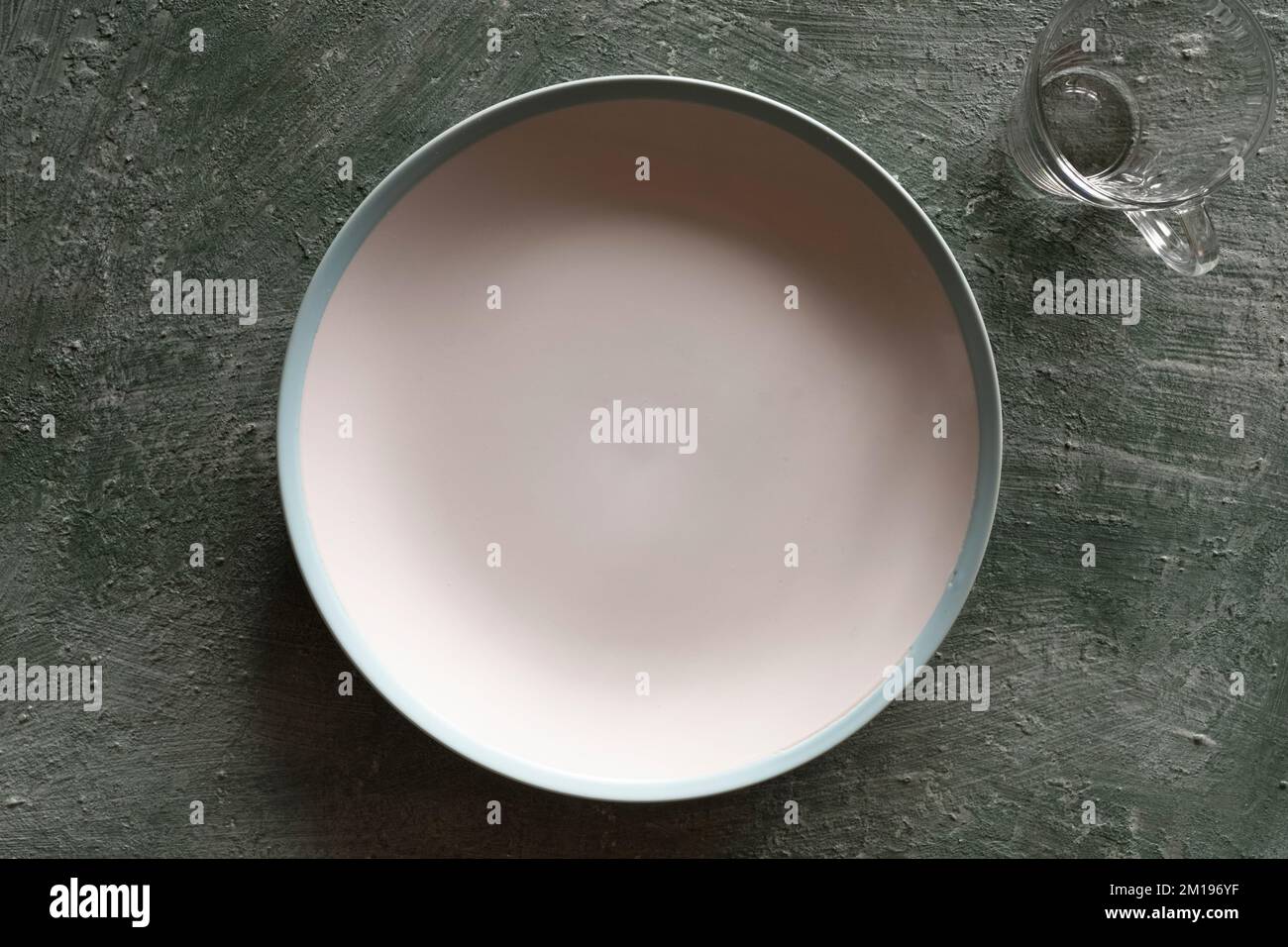 empty plate and cutlery on stone green background, top view Stock Photo ...