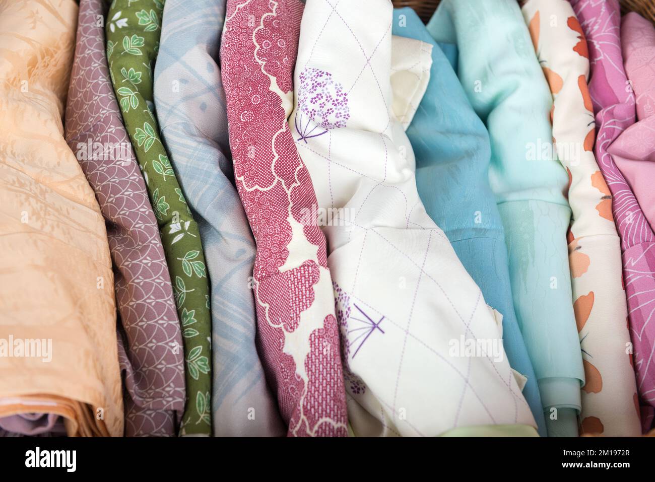 A set of folded fabrics of different colors and textures inside a ...