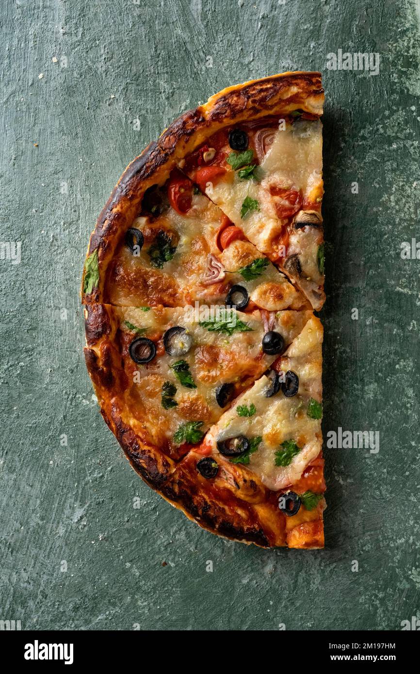 half a delicious homemade italian pizza on the table, pizza with wine ...