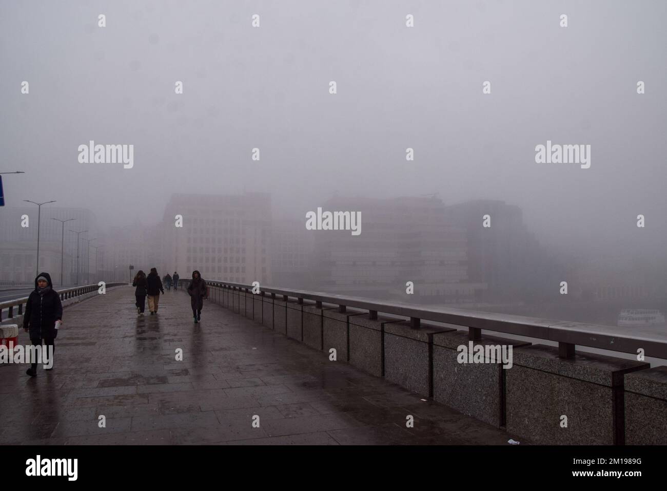 London, UK. 11th December 2022. People walk along London Bridge past ...