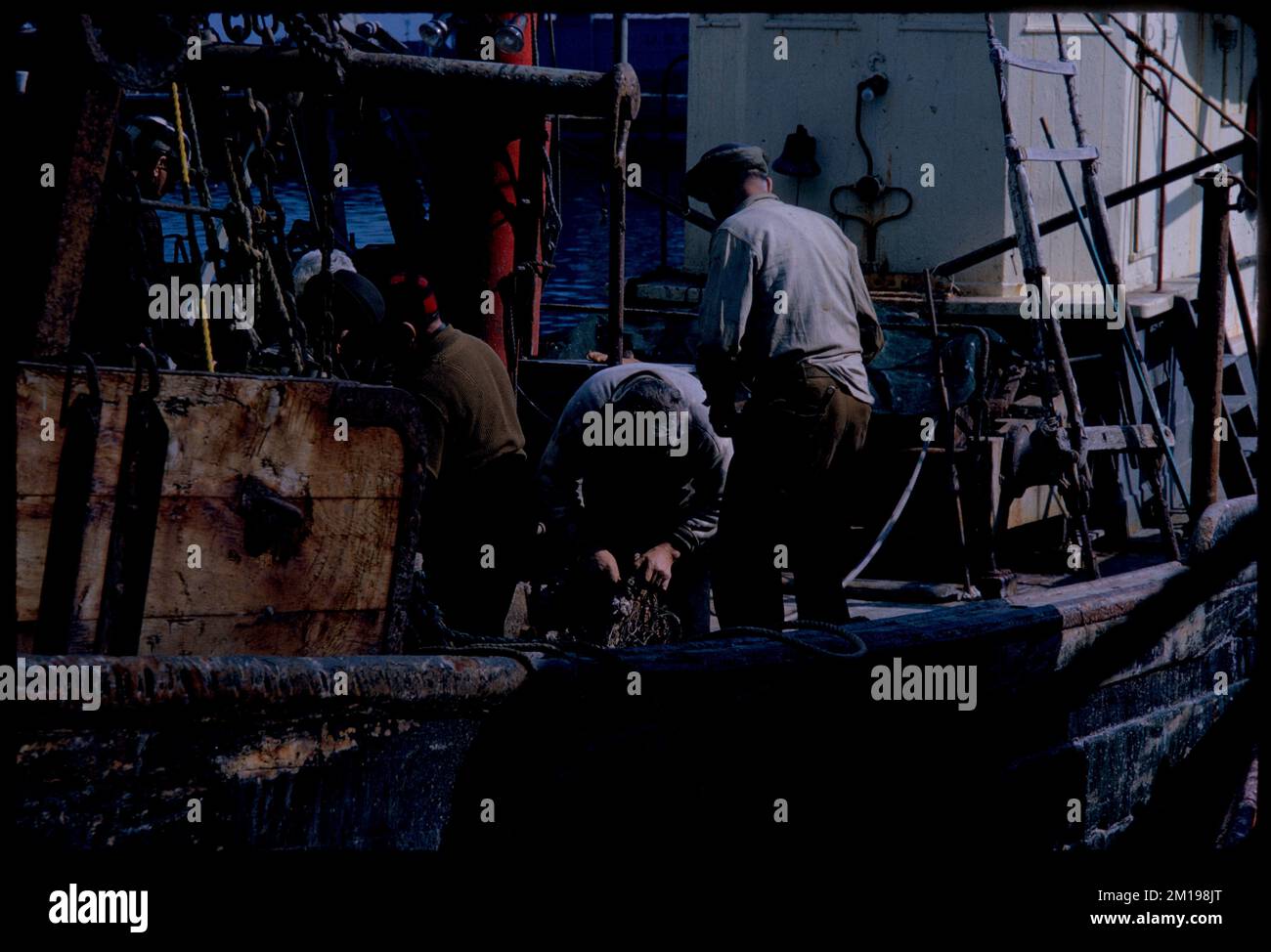 Three people working on a boat , Boats, Laborers. Edmund L. Mitchell ...