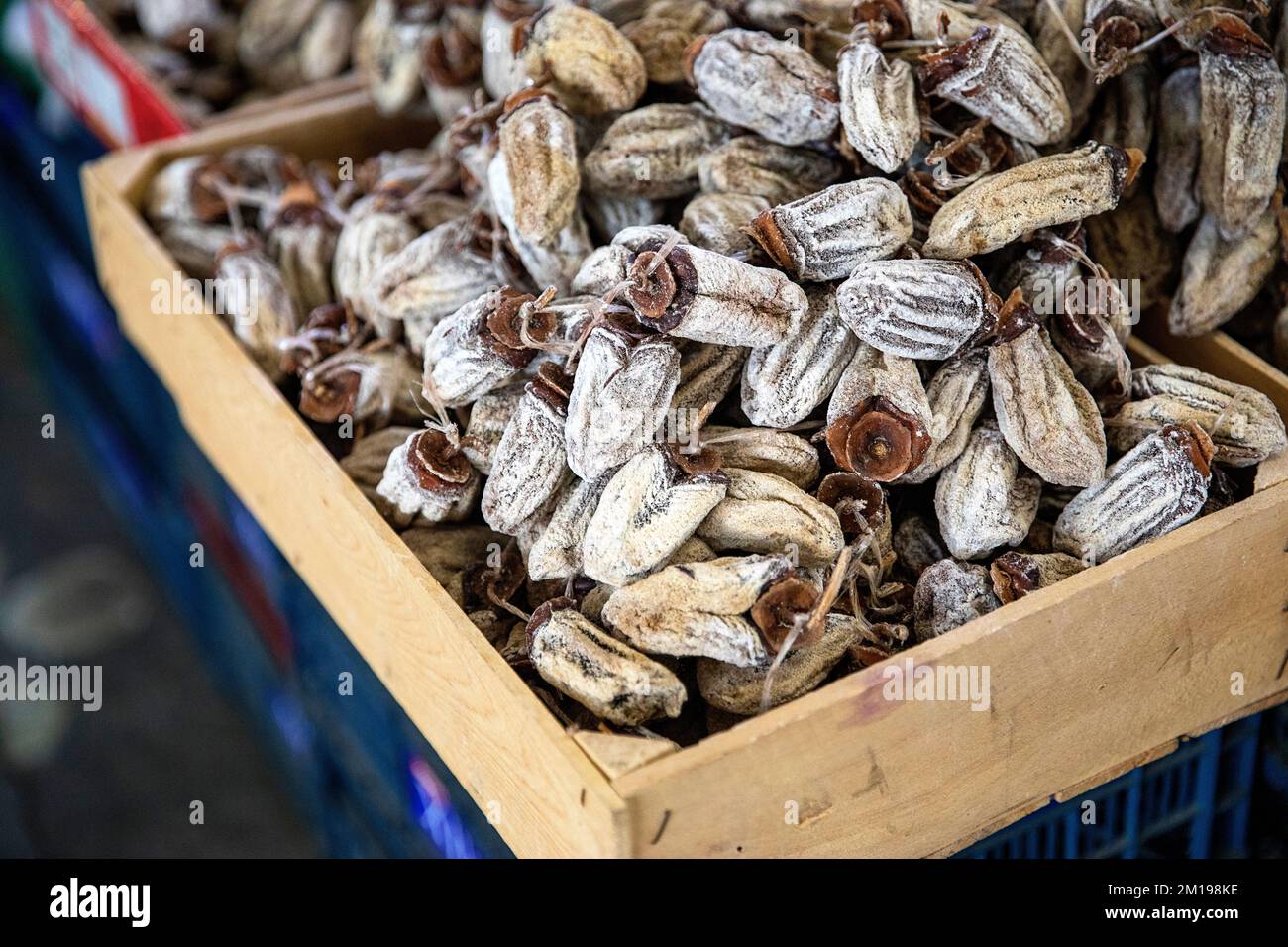 Dried persimmon fruit in a wooden crate box beeing sold on the ...