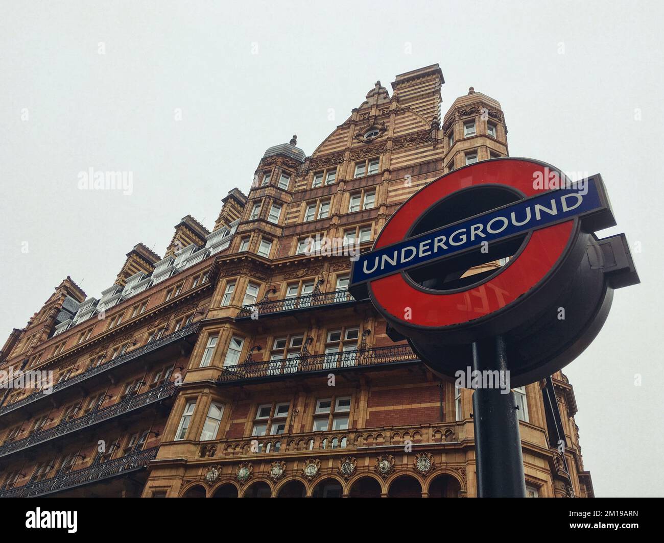 A closeup of a subway symbol on a building background in London street ...