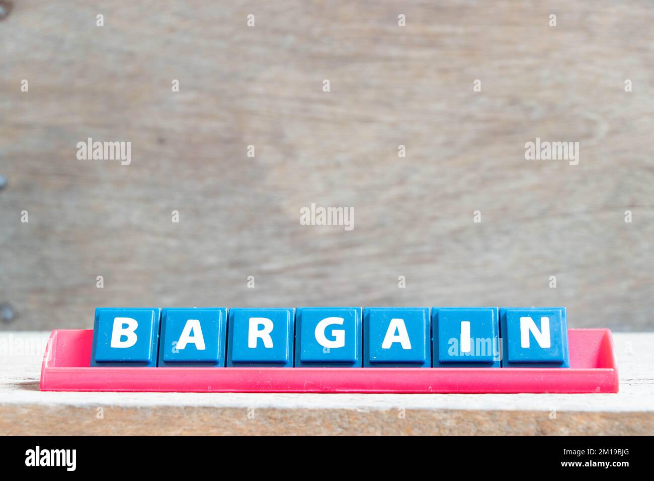 Tile alphabet letter with word bargain in red color rack on wood ...