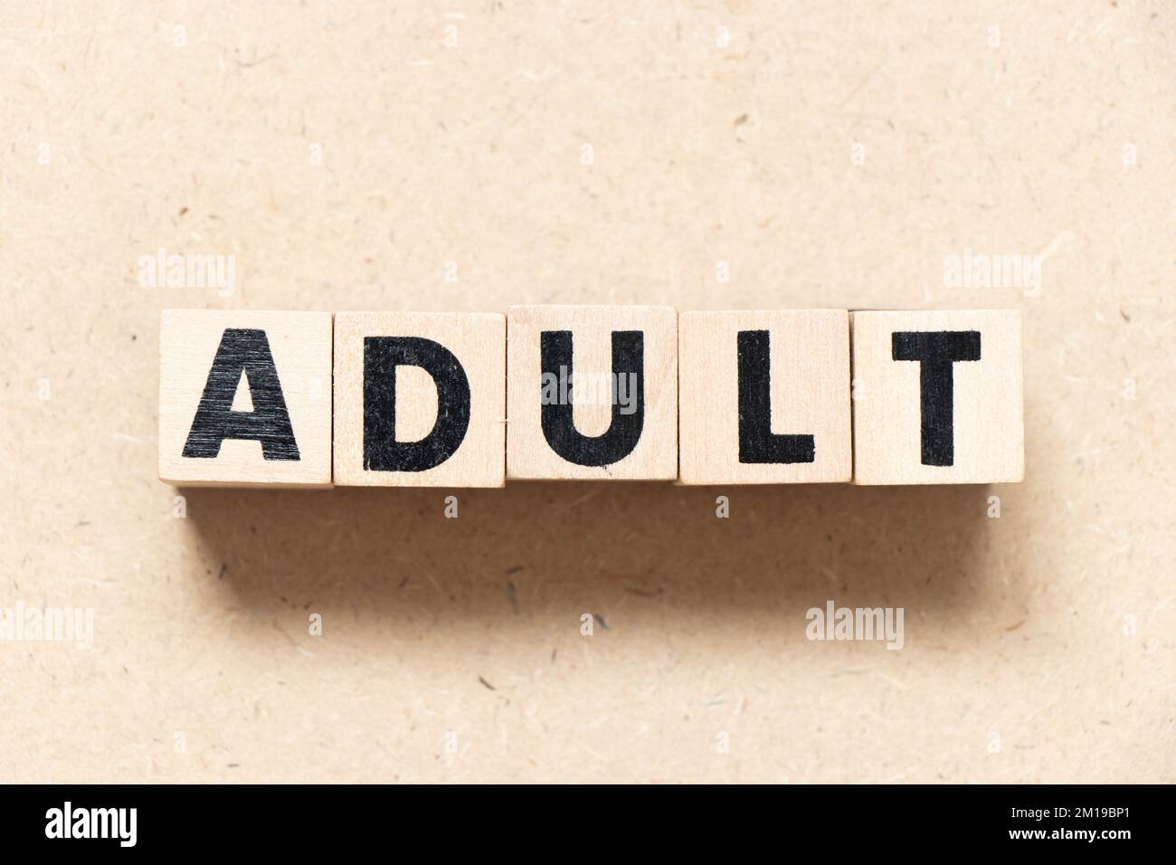 Alphabet letter block in word adult on wood background Stock Photo - Alamy