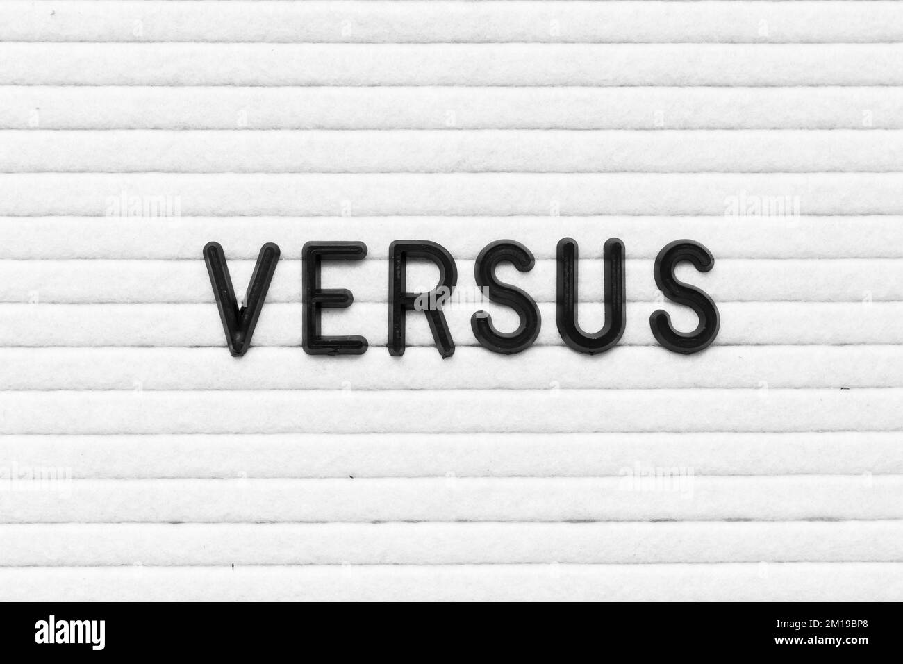 Black color letter in word versus on white felt board background Stock ...