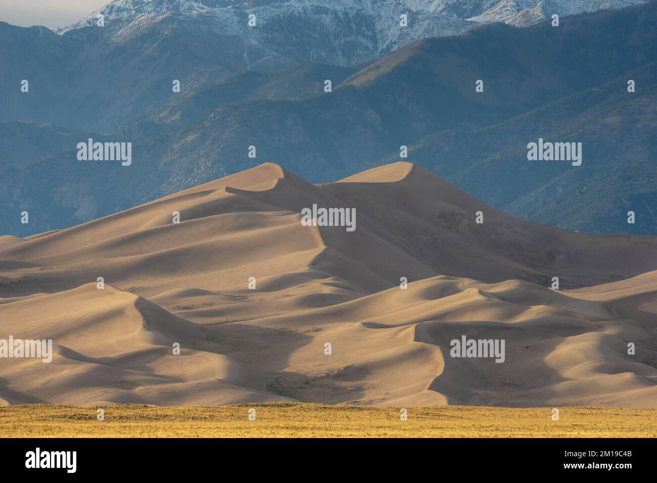 Star Dune Rises From The Valley Floor With Mountains In The Distance in ...