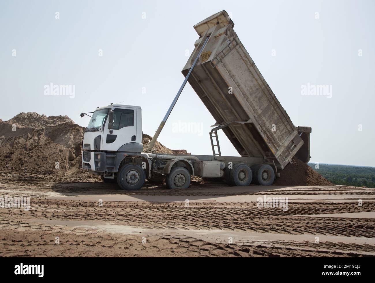 gray dump truck at the construction site in the process of transporting ...