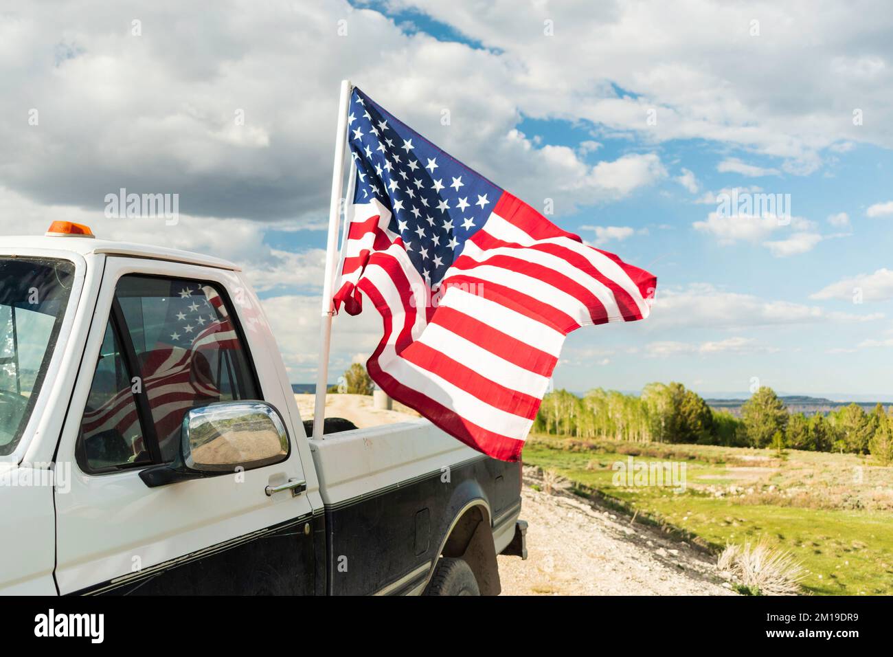 The American Flag Flying from a Good Old Truck on a Country Road in the ...