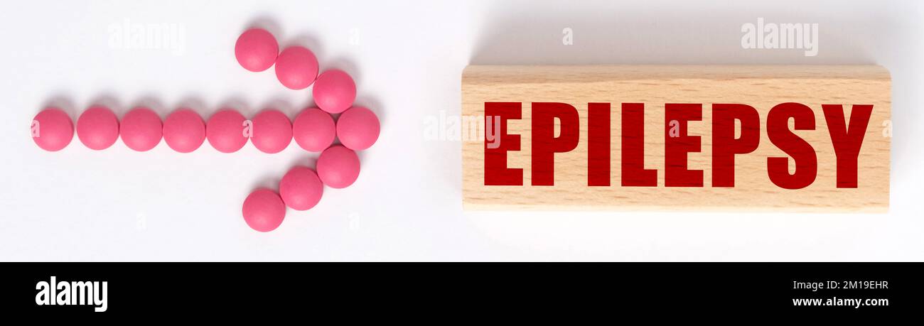 Medicine concept. An arrow of pills points to a sign that says EPILEPSY ...