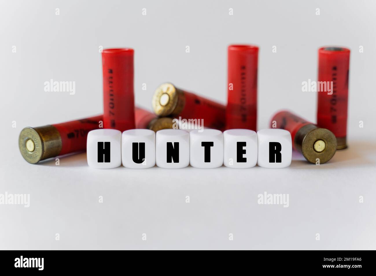 Against the background of rifle cartridges, there are white cubes with ...