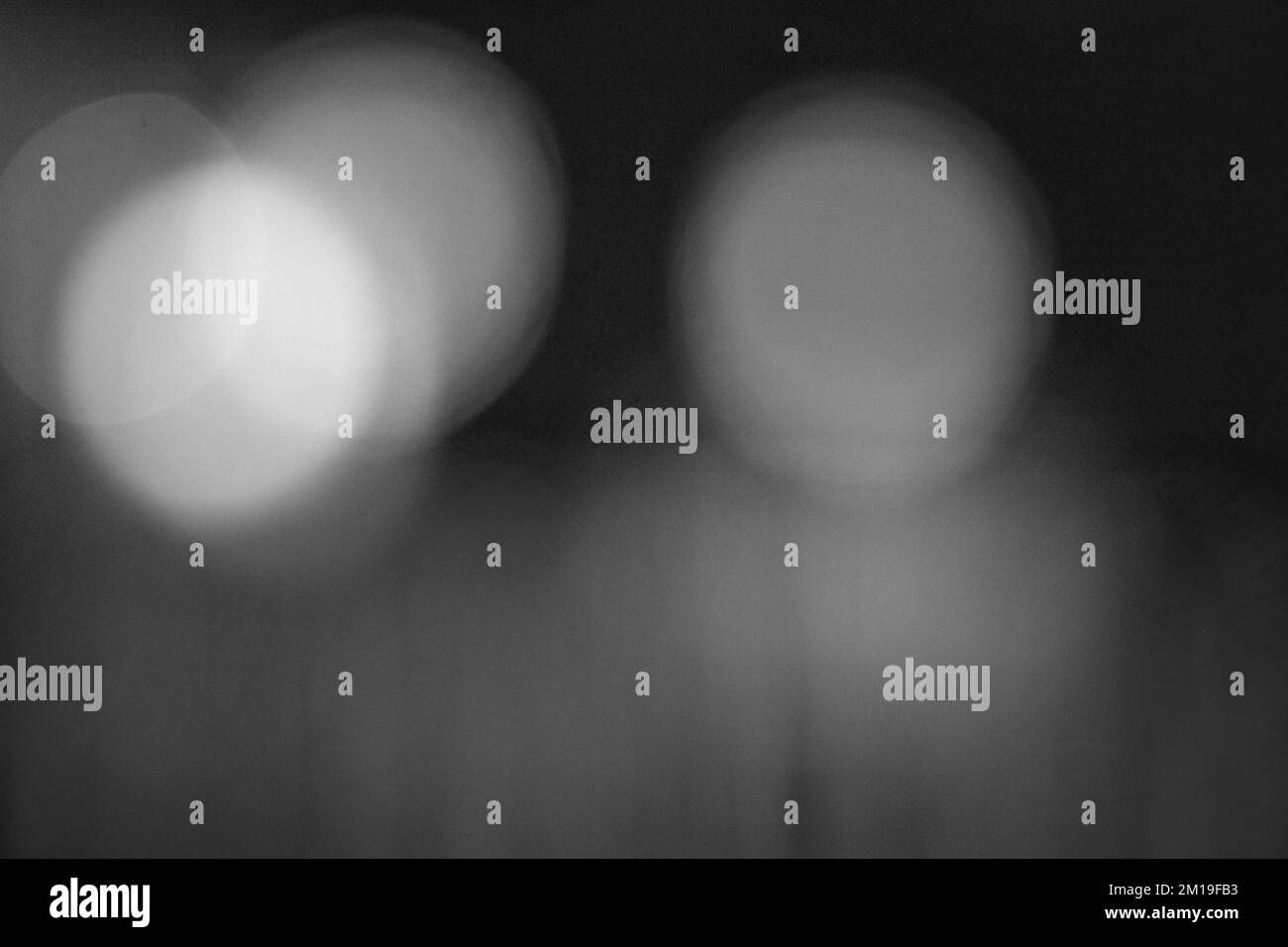 Blurry dreamy view of bright lights in a black and white monochrome ...