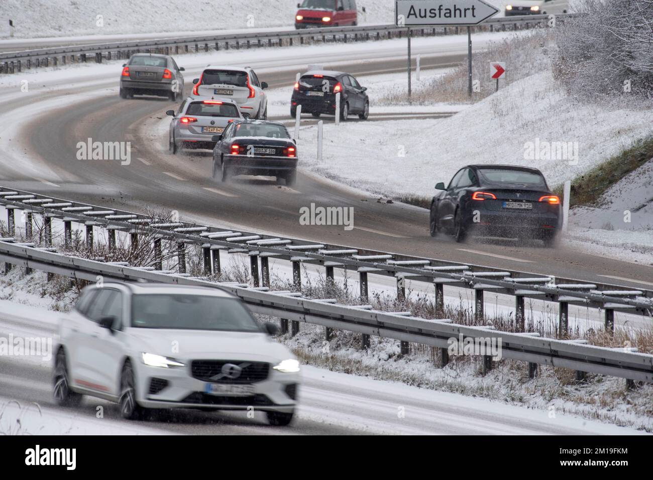 Rostock, Germany. 11th Dec, 2022. Passenger cars driving on the snow ...