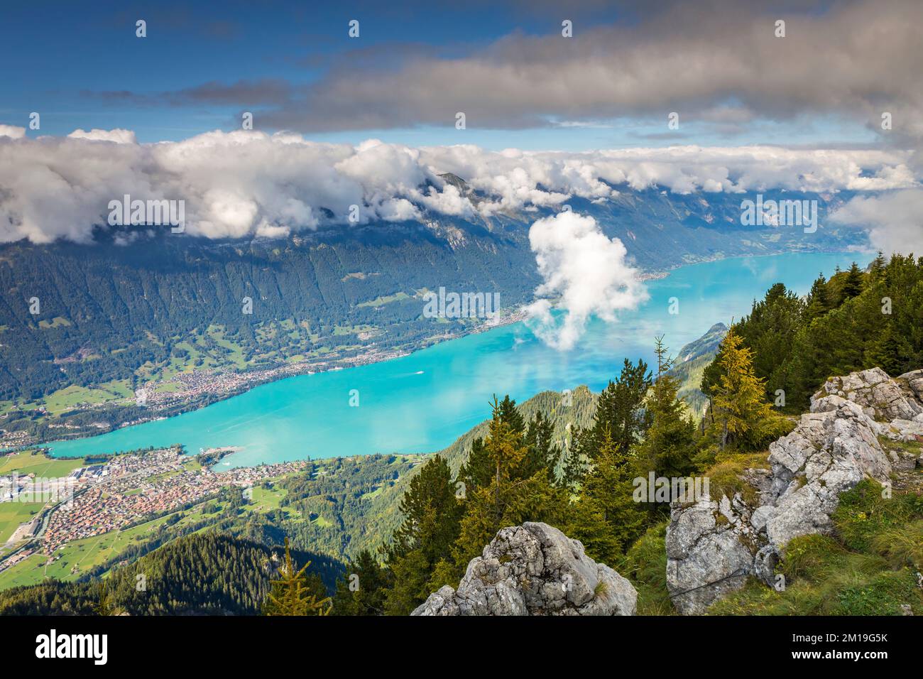 Aerial view of Swiss Alps and Lake Brienz with ferry boat at sunset ...