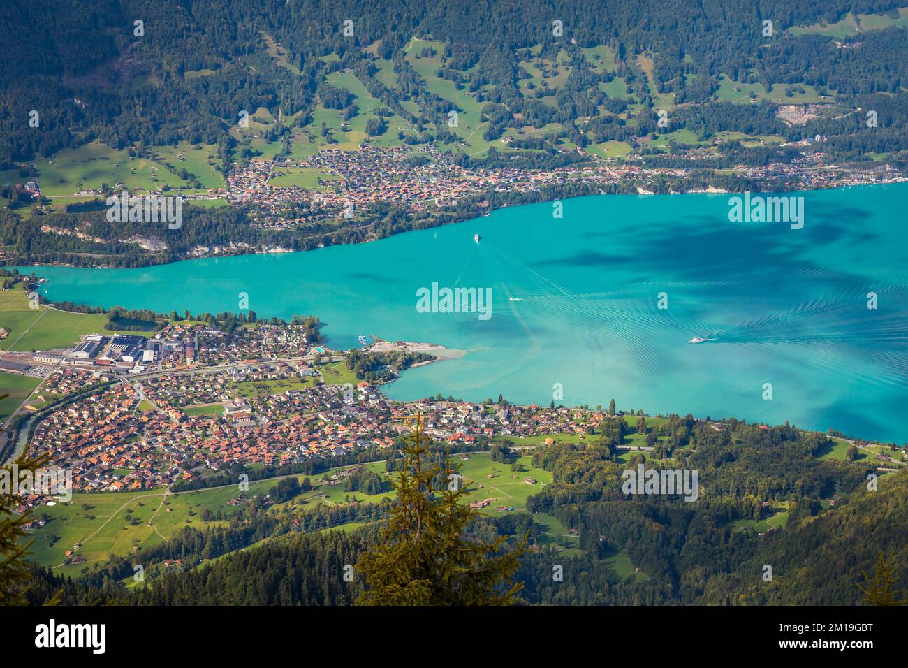 Aerial view of Swiss Alps and Lake Brienz with ferry boat at sunset ...