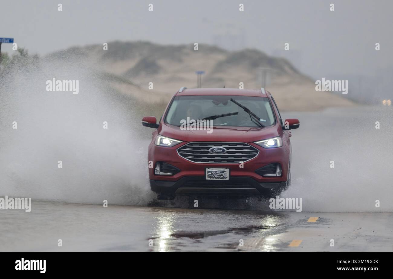 Car going through floods at speed on wet winter's day. Texas Stock ...