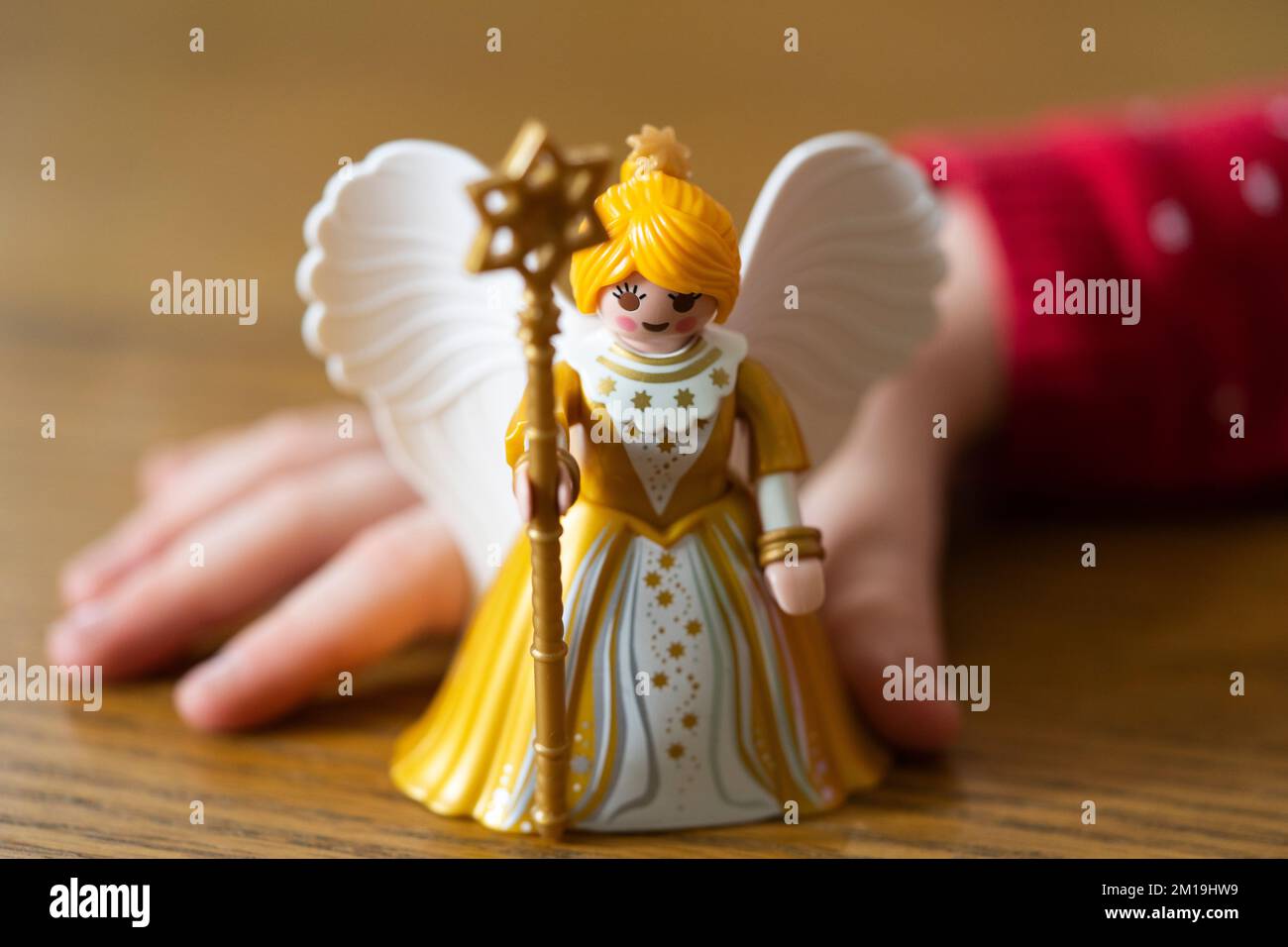 Young child's hand holding a Duplo figure of the the children's gift ...