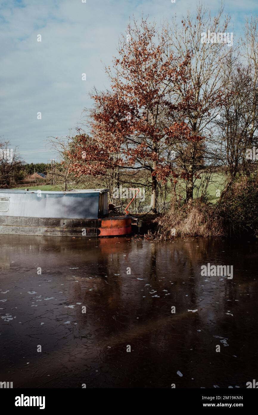 A moored canal boat, sitting underneath a beautiful tree, influenced by ...