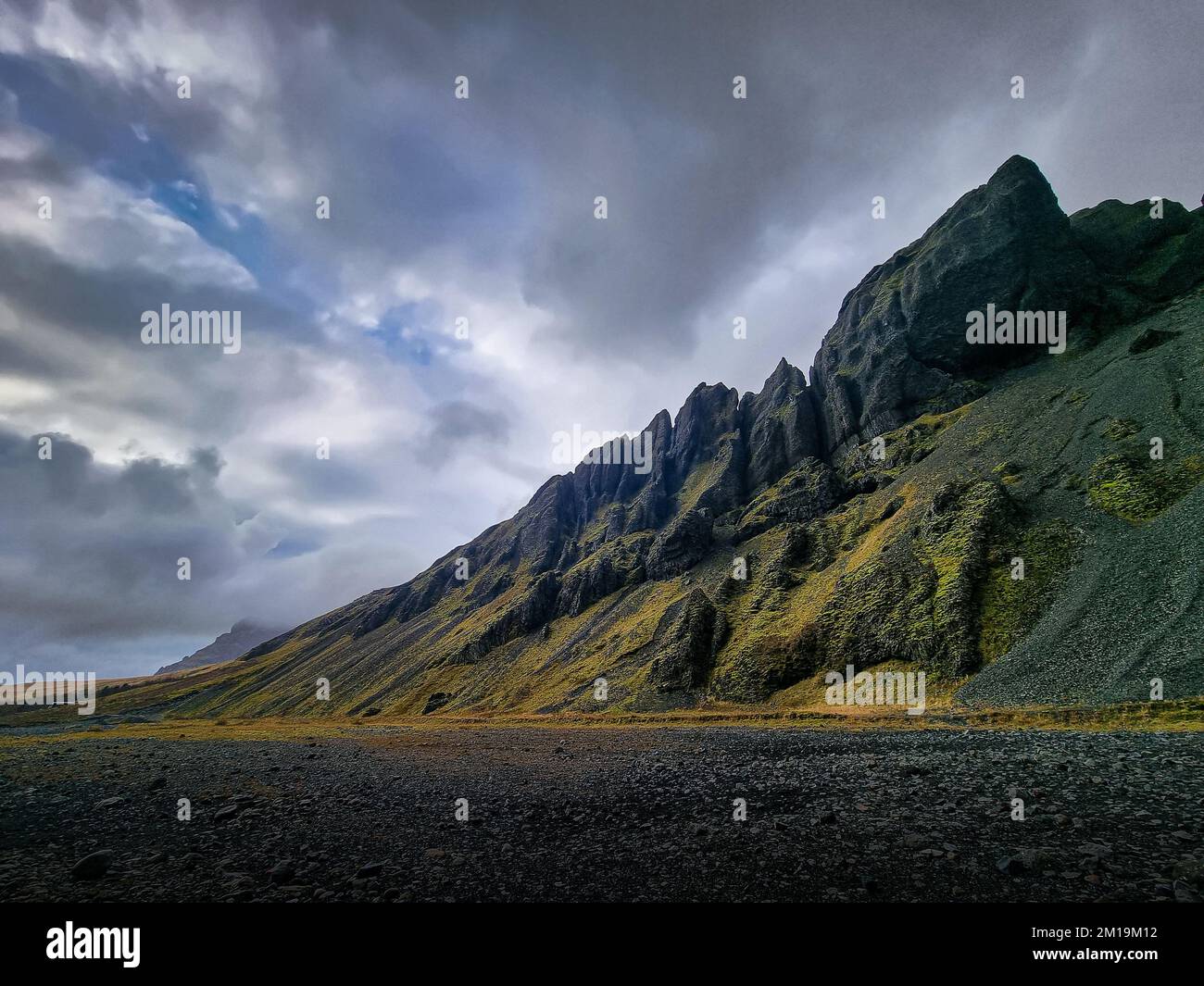 Dramatic icelandic mountain landscape under cloudy sky with rugged ...