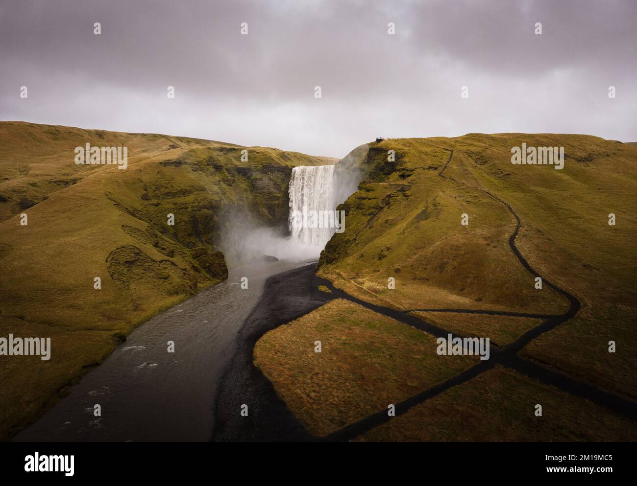 Scenic waterfall Skogafoss in a serene valley in Golden Circle in ...