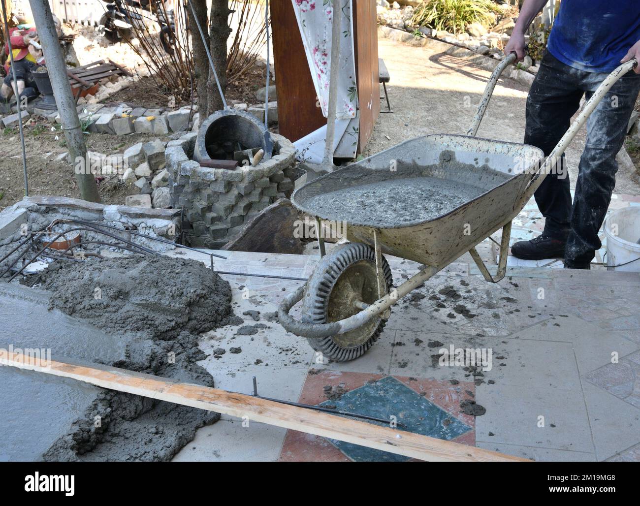 Construction of the floor at the house by hand using a wheelbarrow ...