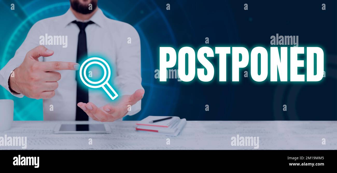 Hand writing sign Postponed. Word for to place later in order of ...