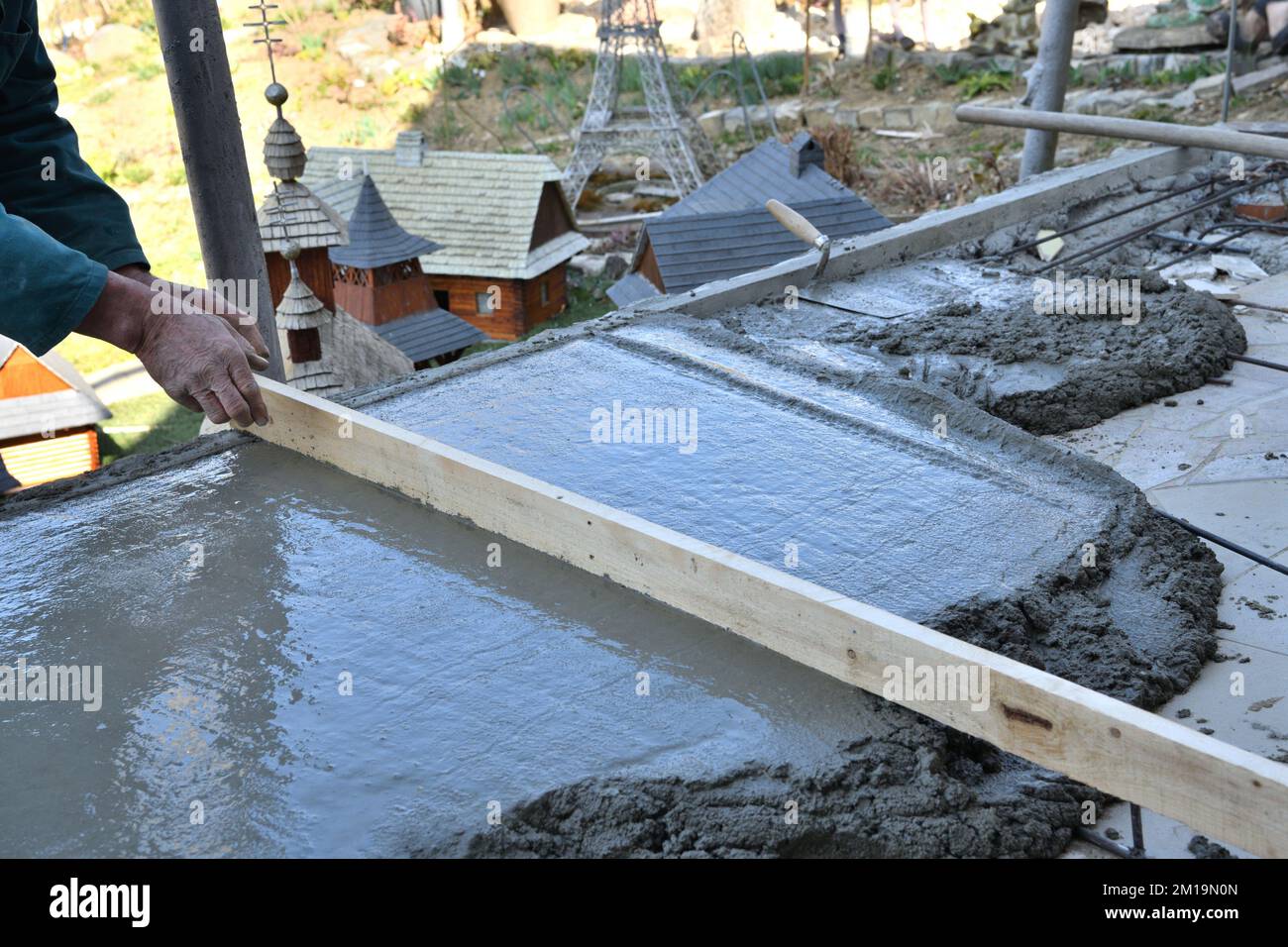 The mason balances freshly poured concrete into the flat surface Stock ...