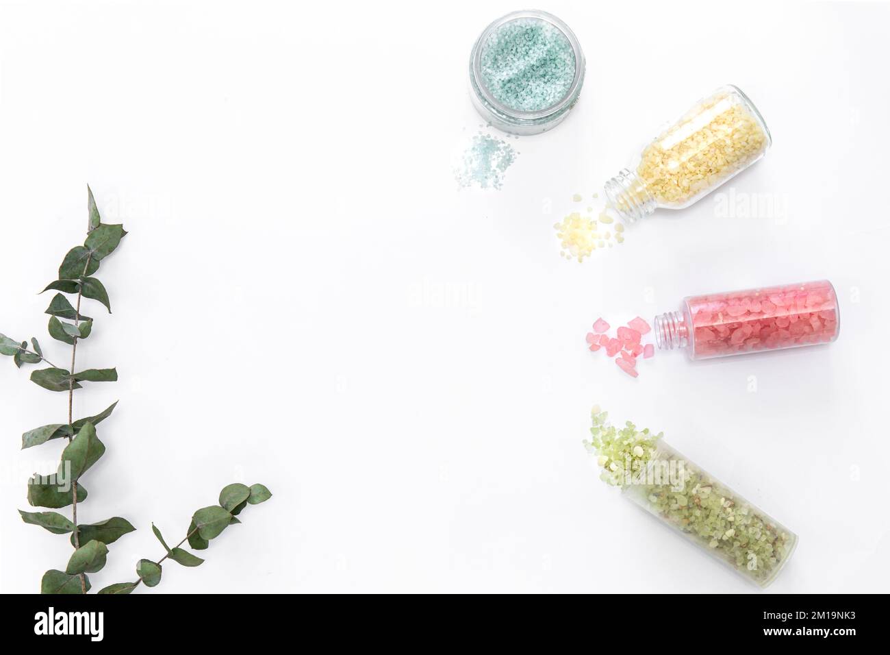 Flat lay, sea salt of different colors on a white background isolated ...