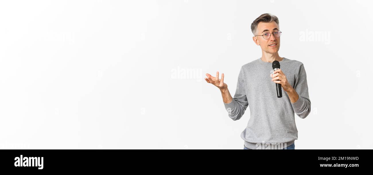 Portrait of handsome middle-aged man in glasses and gray sweater ...